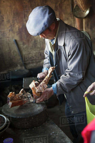 Naxi Chinese Man Chops Dried Meat; Lijiang, Yunnan Province, China ...