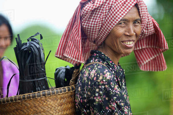 Portrait Of Bunong Woman With Basket On Her Back; Mondulkiri, Cambodia ...
