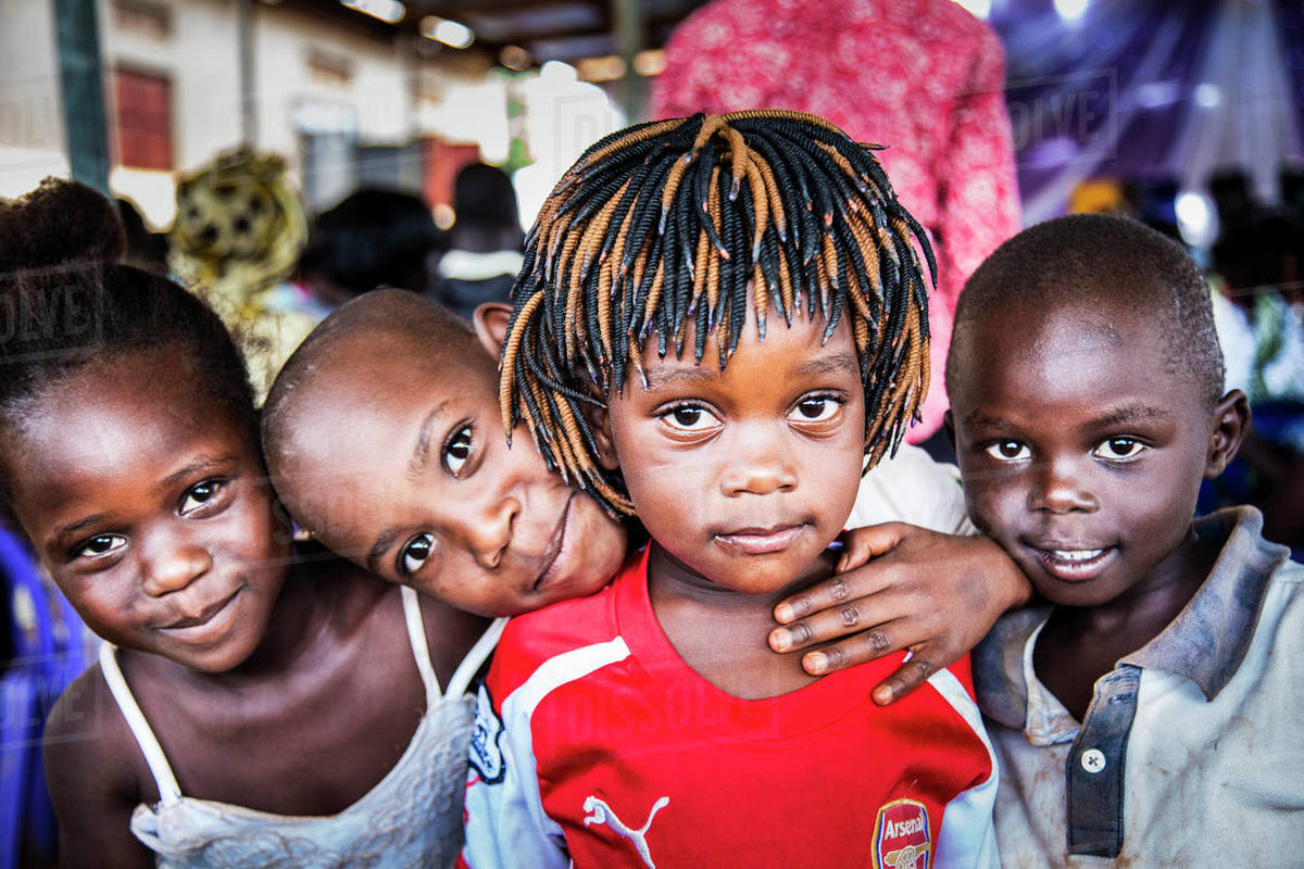 Portrait Of Four Ugandan Children; Gulu, Uganda - Stock Photo - Dissolve