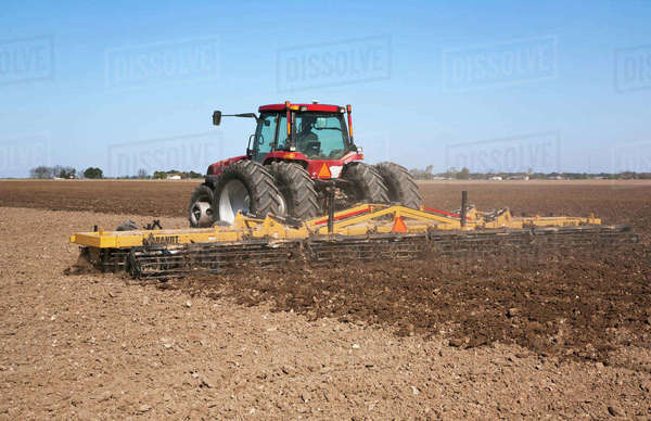 Agriculture - A Case IH tractor and field implement prepare bedded soil ...