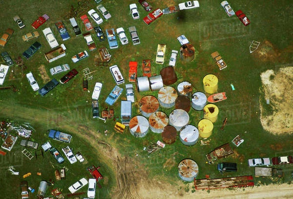 Agriculture - Aerial view of a farm junkyard with old cars, tanks and ...