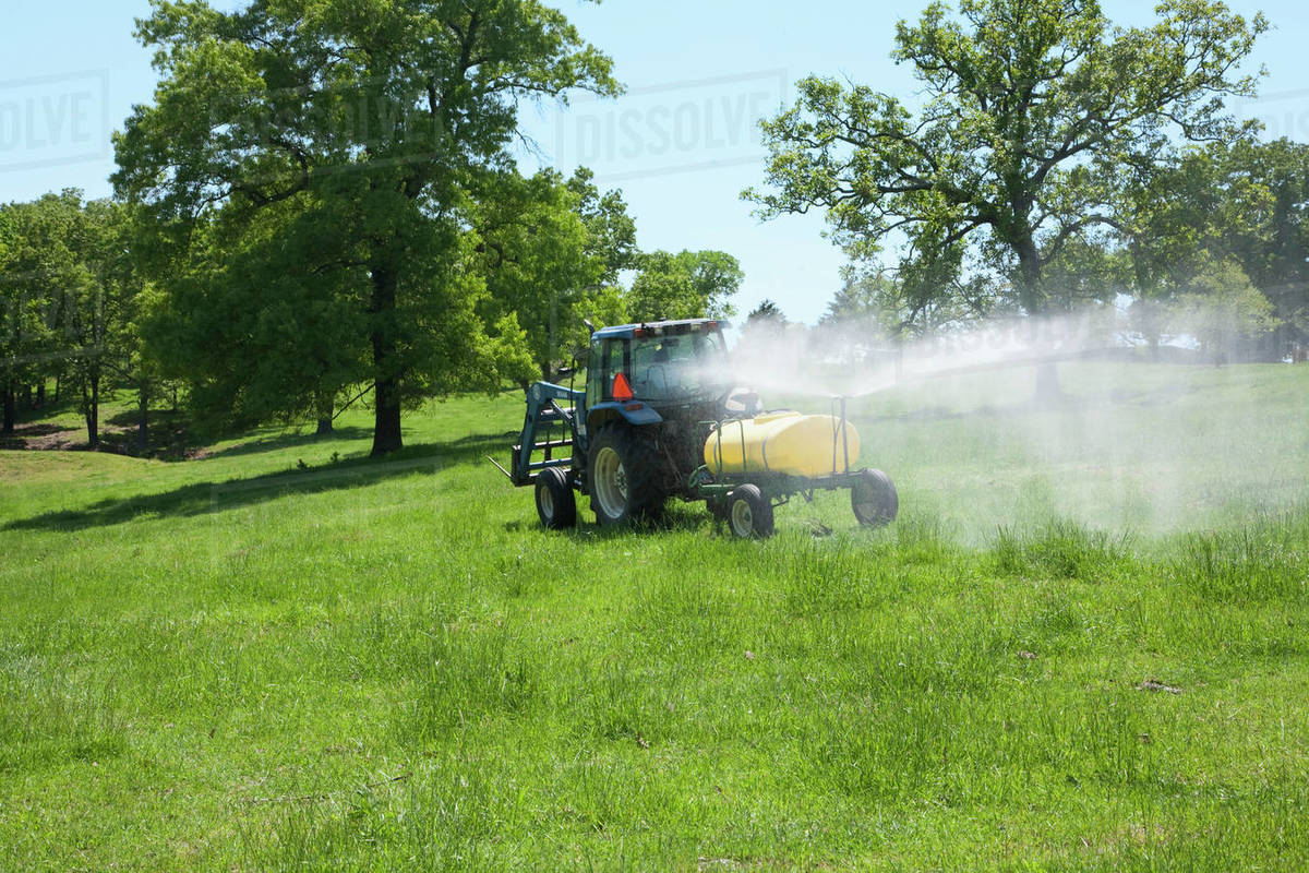 Agriculture - Spraying herbicide on a pasture used for grazing beef ...