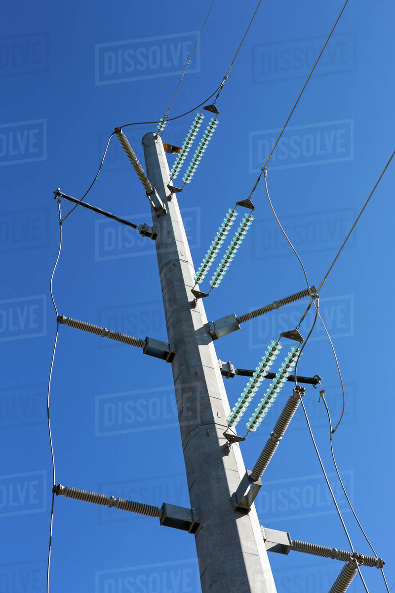 Low angle view of large metal hydro tower with glass insulators and ...
