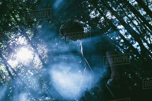 Young man standing in the fog in a forest, Little River State Park ...