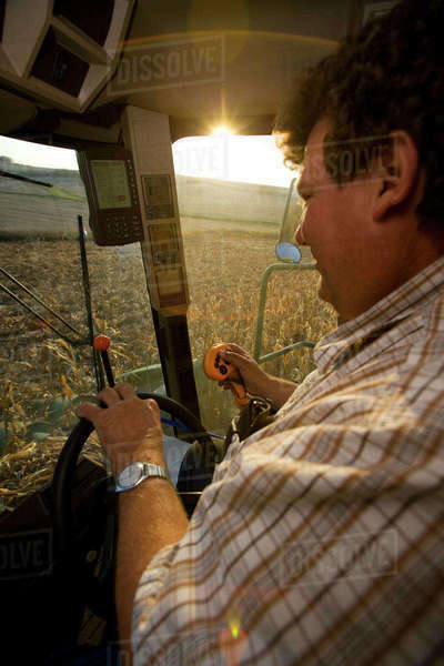 Agriculture - View from inside a combine cab of a farmer operating the ...