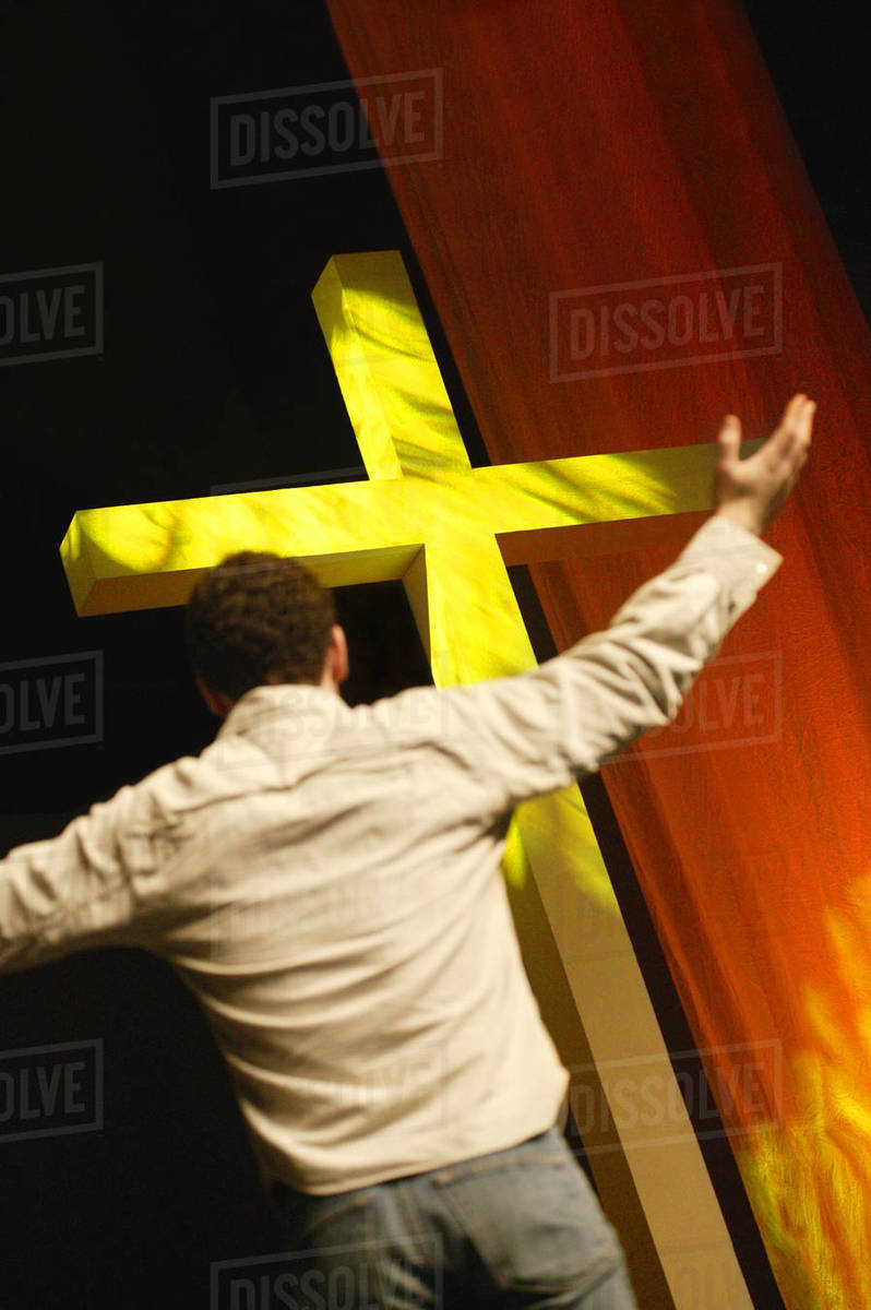 Man Worshipping In Front Of The Cross - Stock Photo - Dissolve