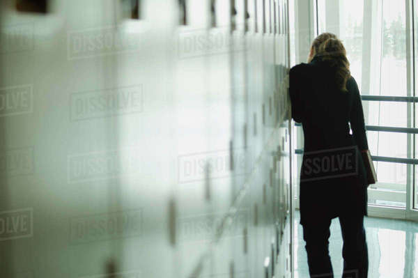 Student Peers Down Hallway - Royalty-free Stock Photo | Dissolve