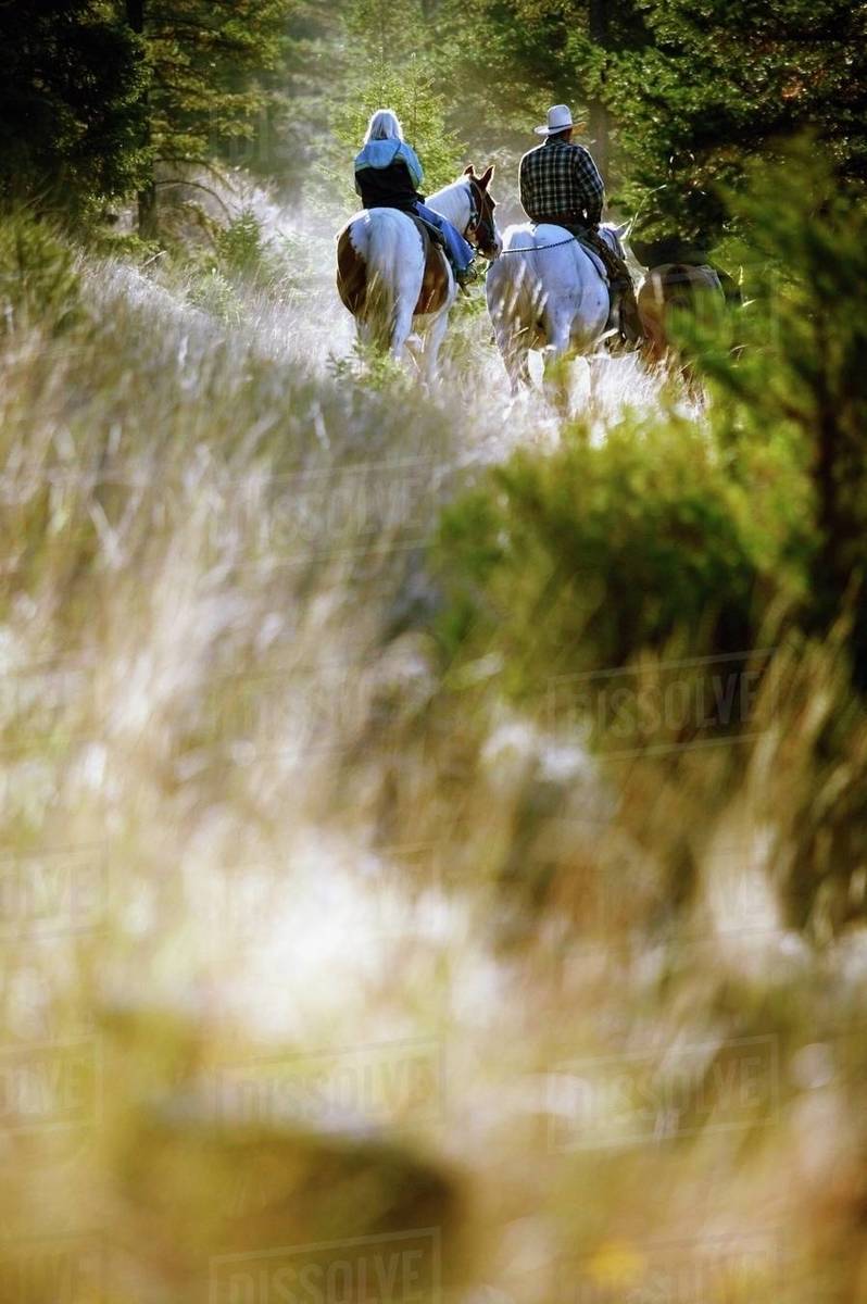 Two People On Horseback - Royalty-free Stock Photo | Dissolve