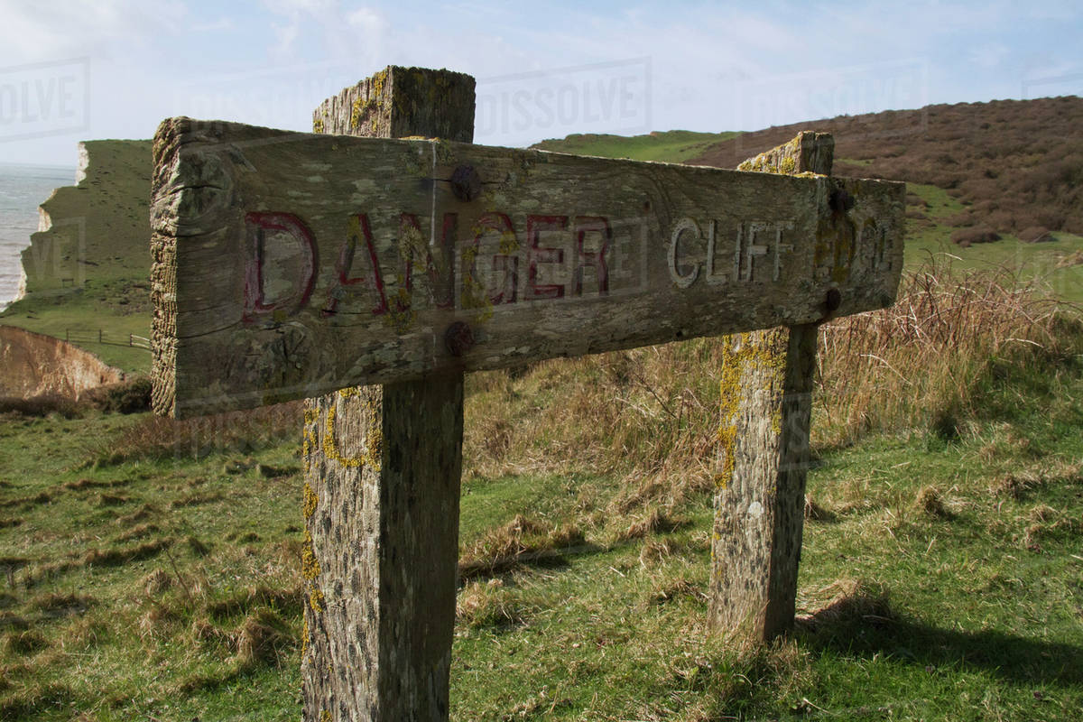 Danger cliff edge wooden sign, Seven Sisters; South Downs, East Sussex ...