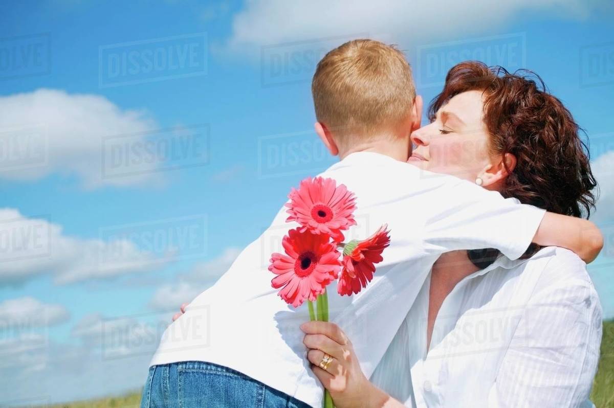 Son Giving Mother Flowers - Royalty-free Stock Photo | Dissolve