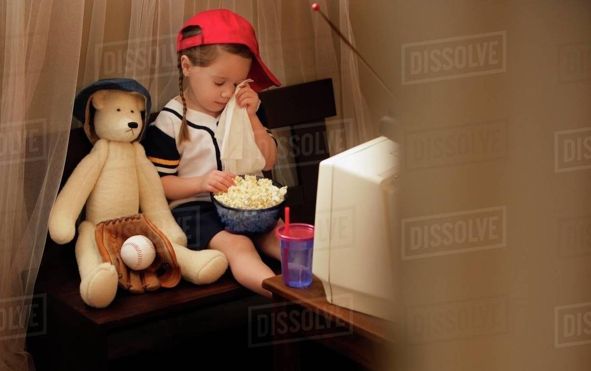 Child Watches Baseball Game On Television - Stock Photo - Dissolve