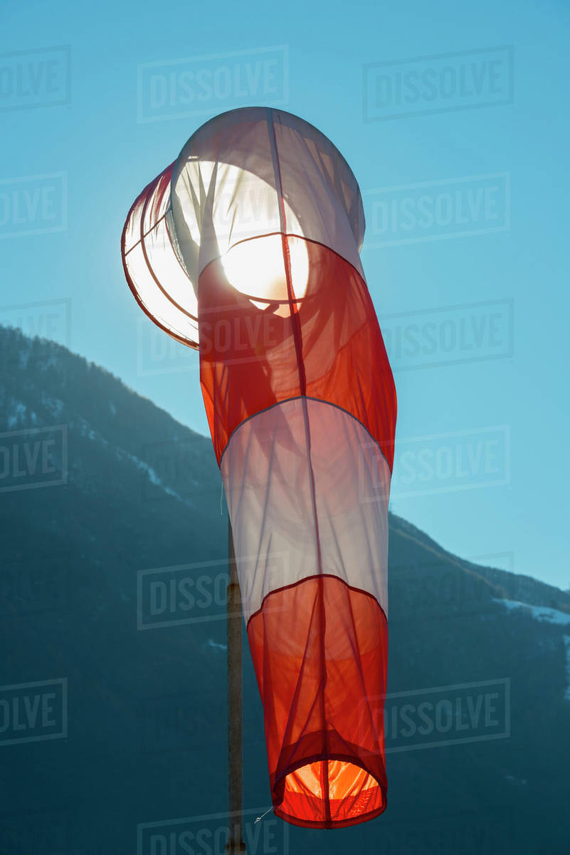 A windsock against a blue sky; Locarno, Ticino, Switzerland - Royalty ...
