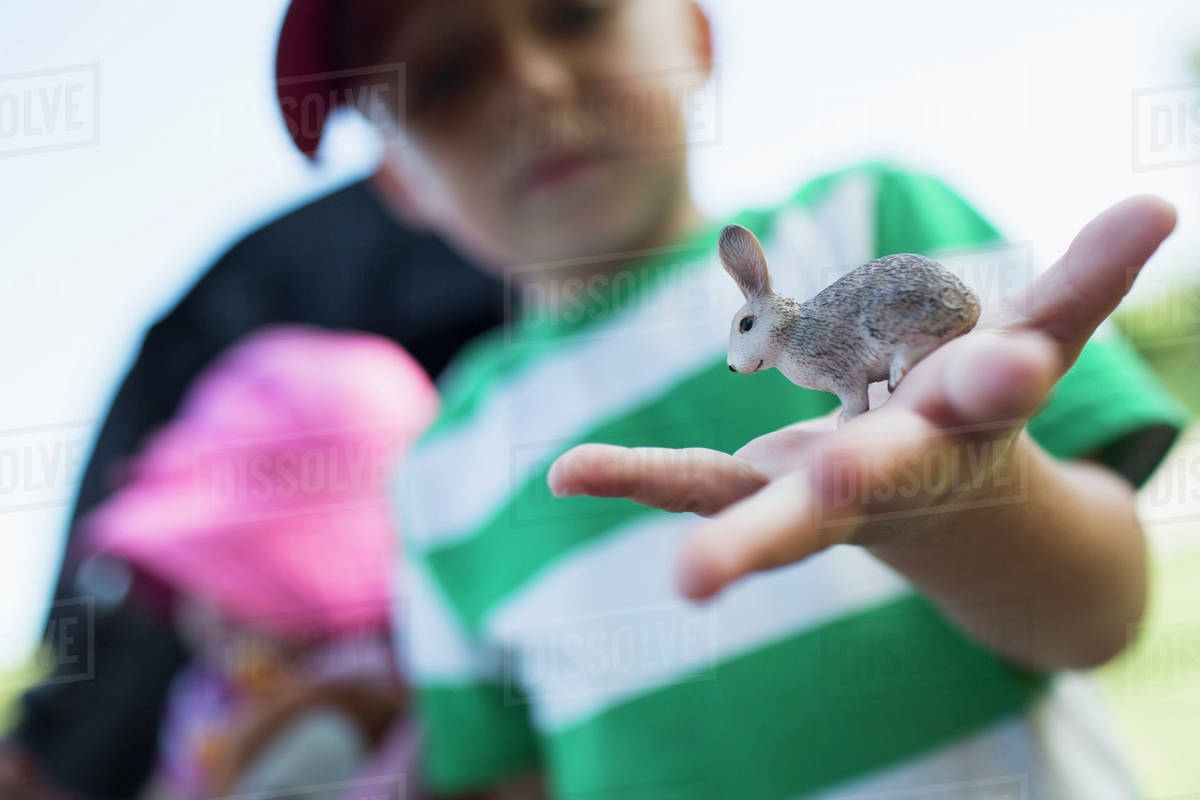 Young boy holding a toy rabbit in his outstretched hand; Toronto ...