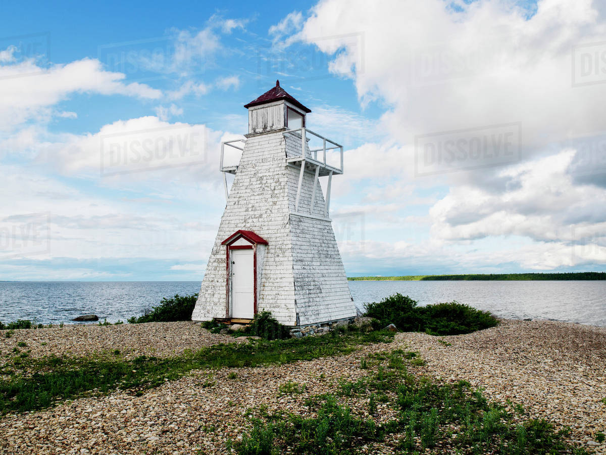 An old white lighthouse on the shore of Lake Winnipeg in Hecla ...