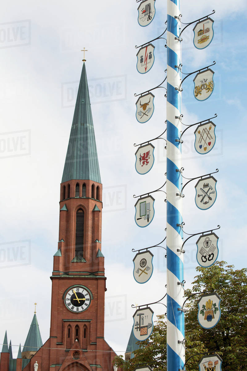 Close up of a traditional bavarian may pole with blue and white stripes ...