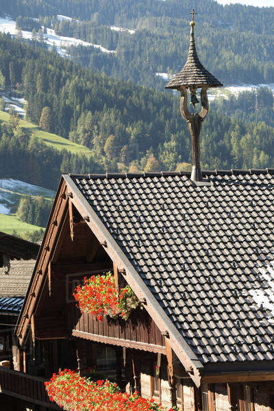 Alpine house top with colourful flower boxes and roof top ornament ...