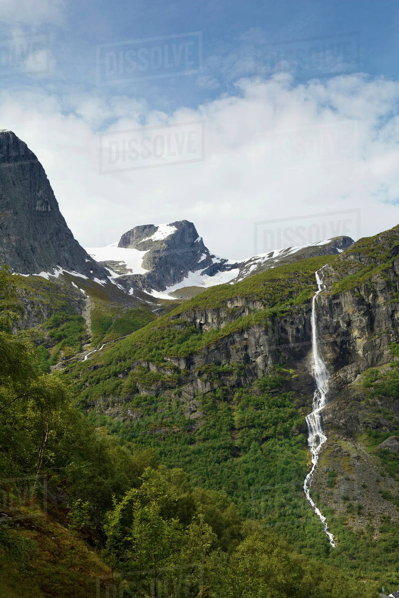 A waterfall down the side of a steep cliff in the mountains; Olden ...