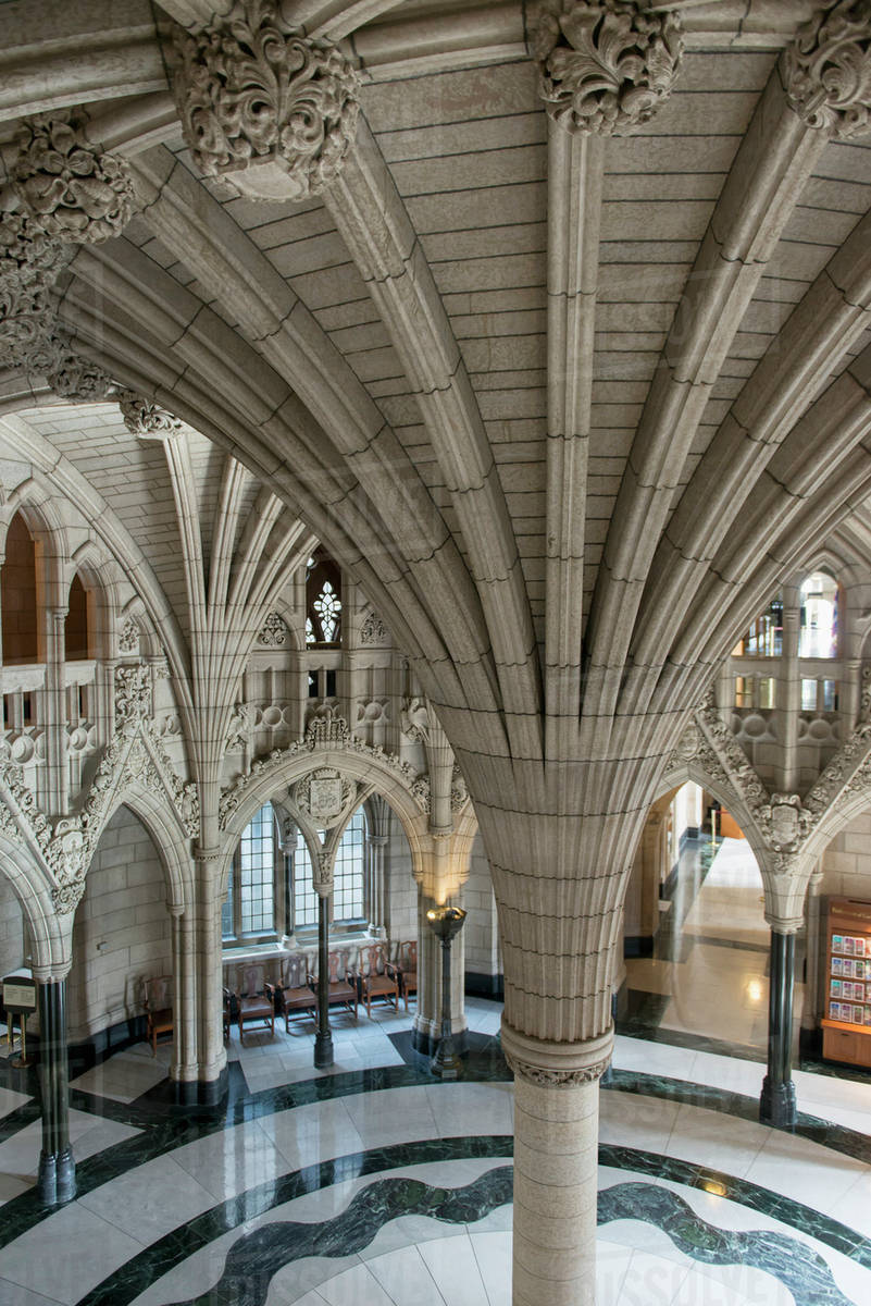 Ornate interior of a building with pillars and black and white flooring ...