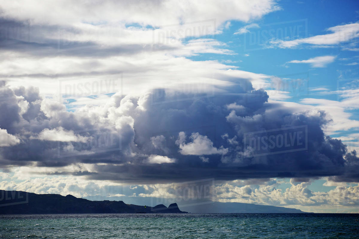 Rain cloud dumping water over the north shore of Maui; Maui, Hawaii ...