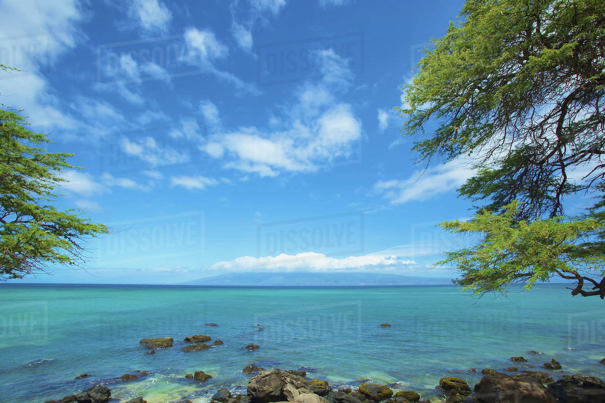 View of the ocean and the mountains along the coastline in the distance ...