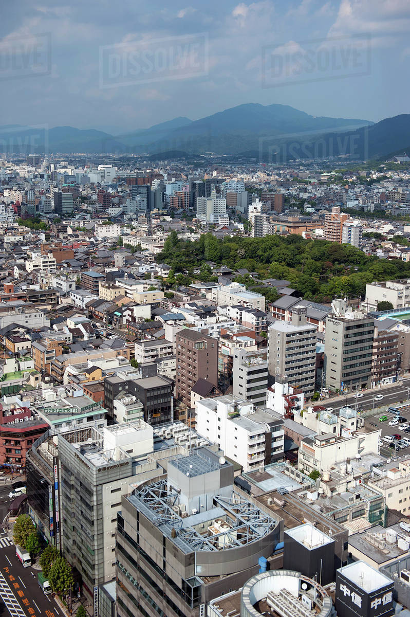 Cityscape With Clouds And Mountains In The Background; Kyoto, Japan ...