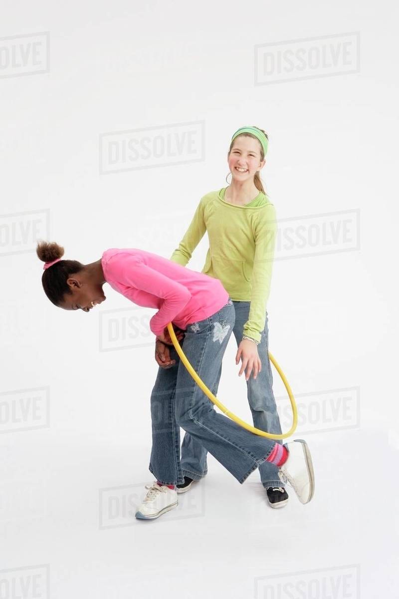 Two Girls Playing With Hula Hoop - Royalty-free Stock Photo | Dissolve