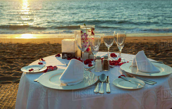 A romantic dinner for two complete with rose petals orchids and a ...