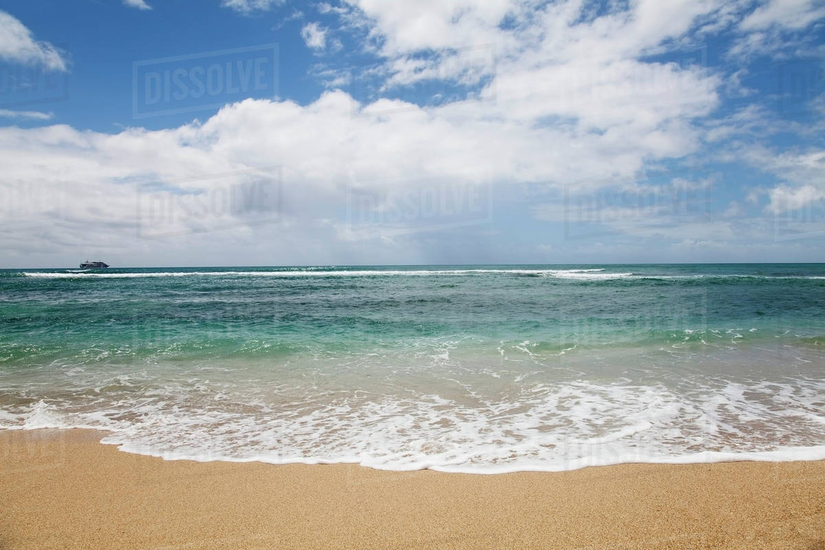 An empty shoreline and a cruise ship in the far distance;Honolulu oahu ...