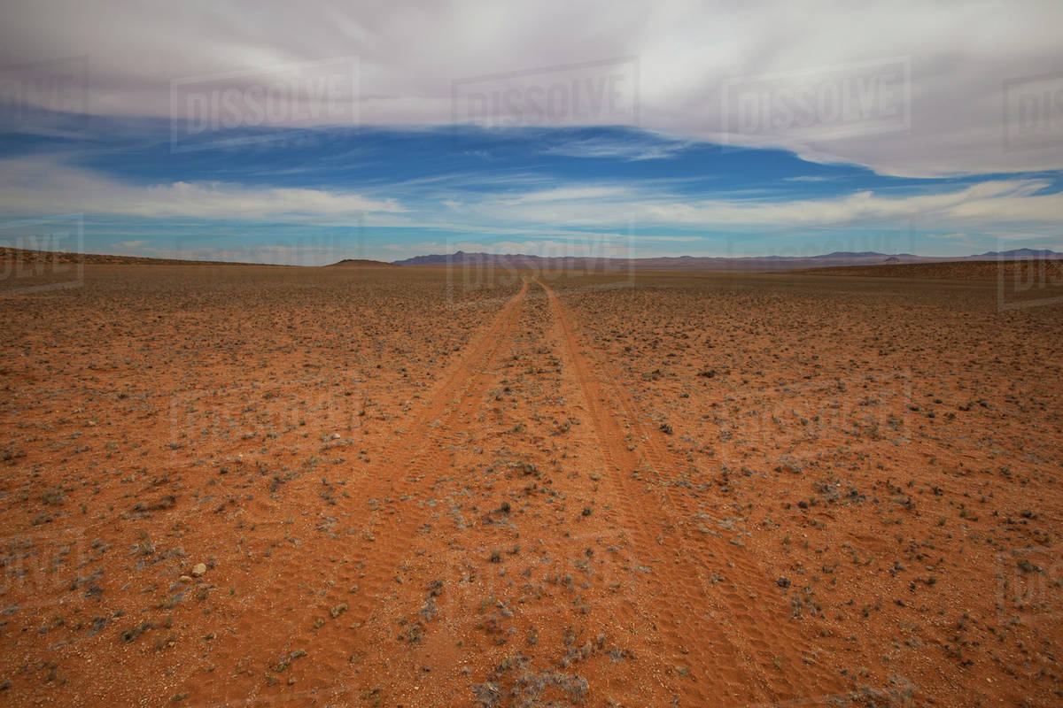 Tire tracks in the dirt on a desert landscape;Klein-aus vista namibia ...