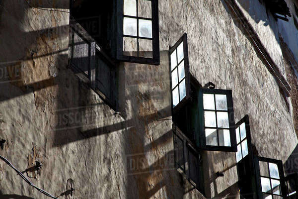 Open windows cast shadows on a building wall; Zanzibar - Royalty-free ...
