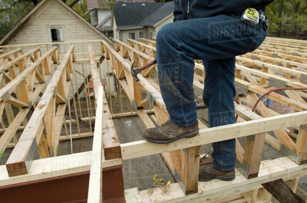 Worker framing a building on a construction site; Lincoln, Nebraska ...