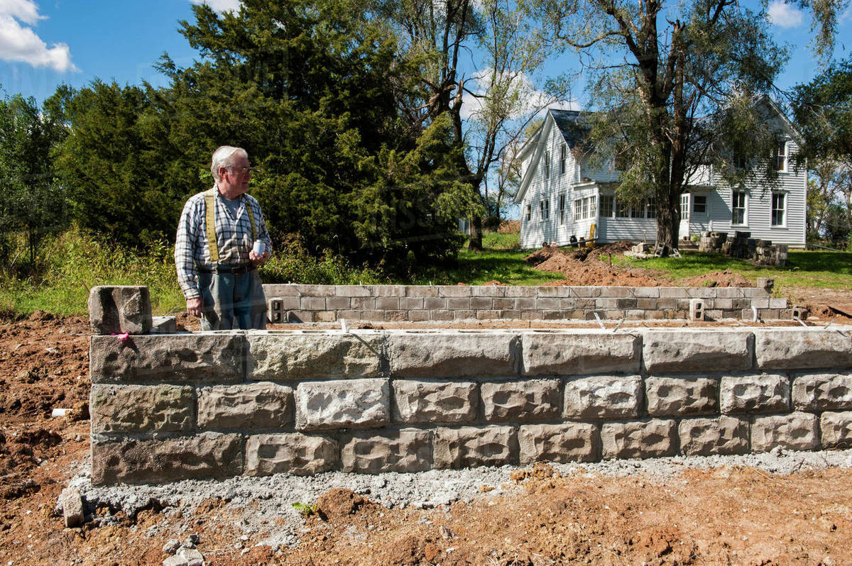 Farmer works on building the foundation for a barn; Dunbar, Nebraska ...