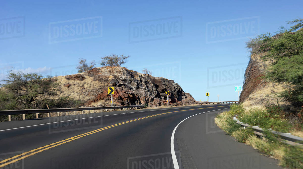 Paved highway with sharp curve in the road through the rocky cliffs on ...