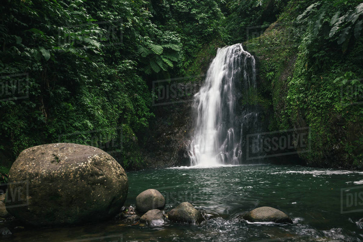 Seven Sisters Waterfalls surrounded by lush vegetation with large ...