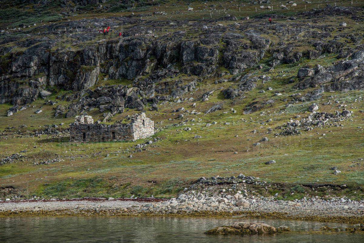 Tour group exploring the archaeological site of Hvalsey, near Qaqortoq ...