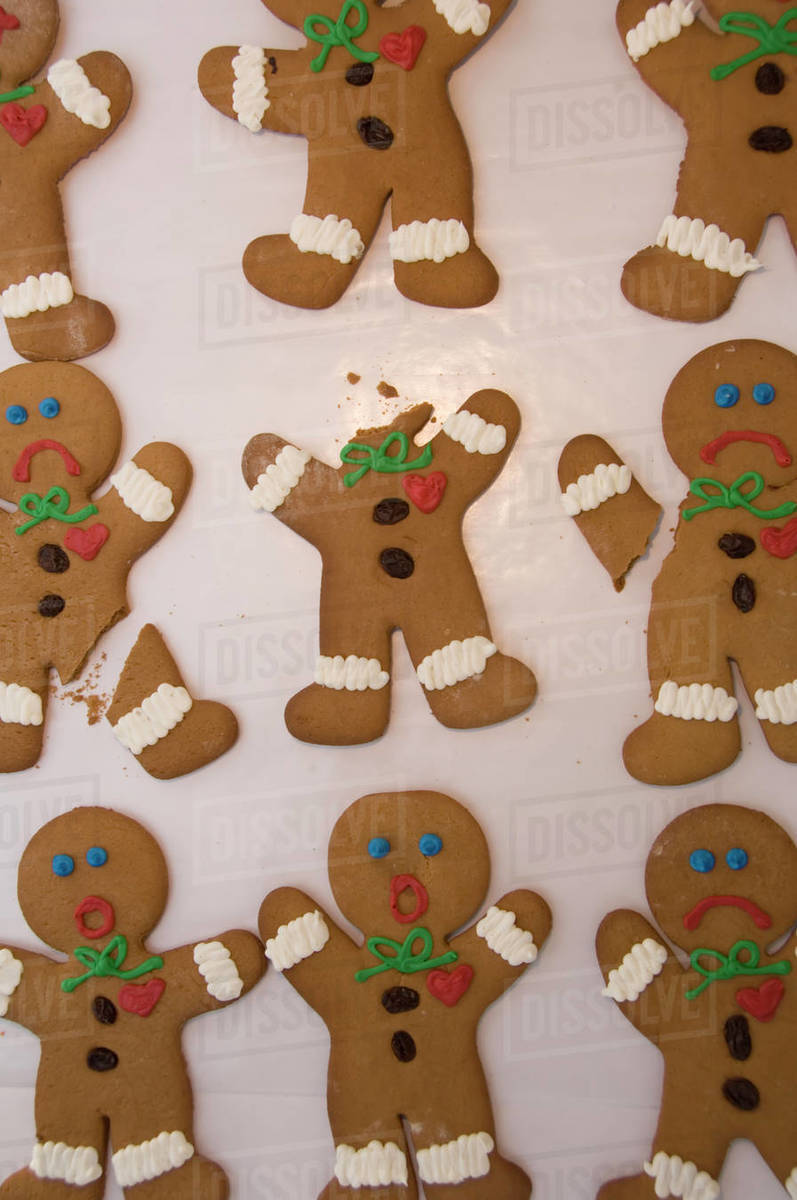 Cookie sheet of gingerbread men with different facial expressions ...