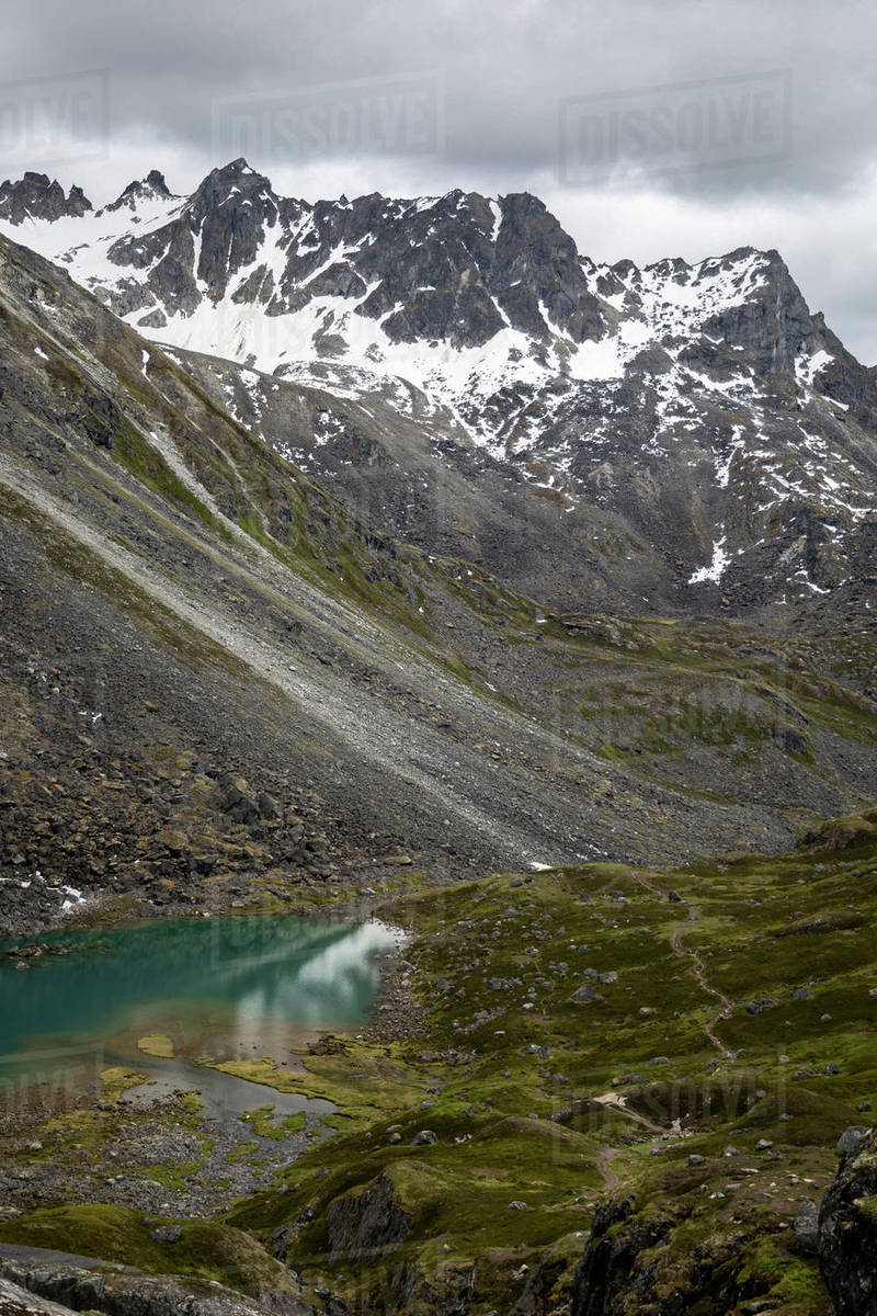 Granite mountain peaks at Hatcher Pass under a grey, cloudy sky with ...