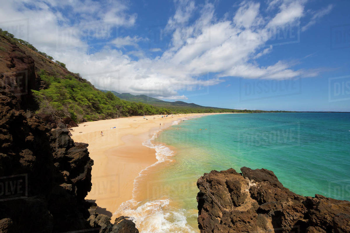 People enjoying the sand and turquoise waters at Makena Beach, Oneloa ...