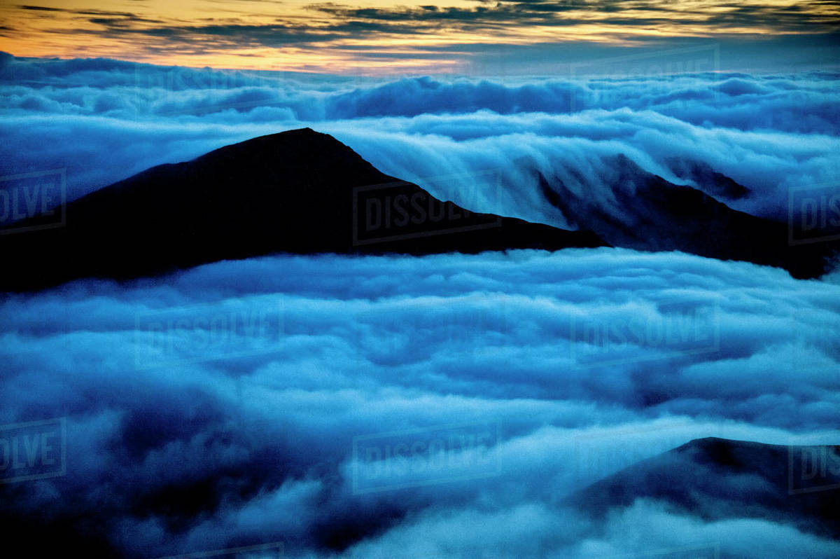 Dawn mist on extinct volcanoes in Haleakala National Park on the ...
