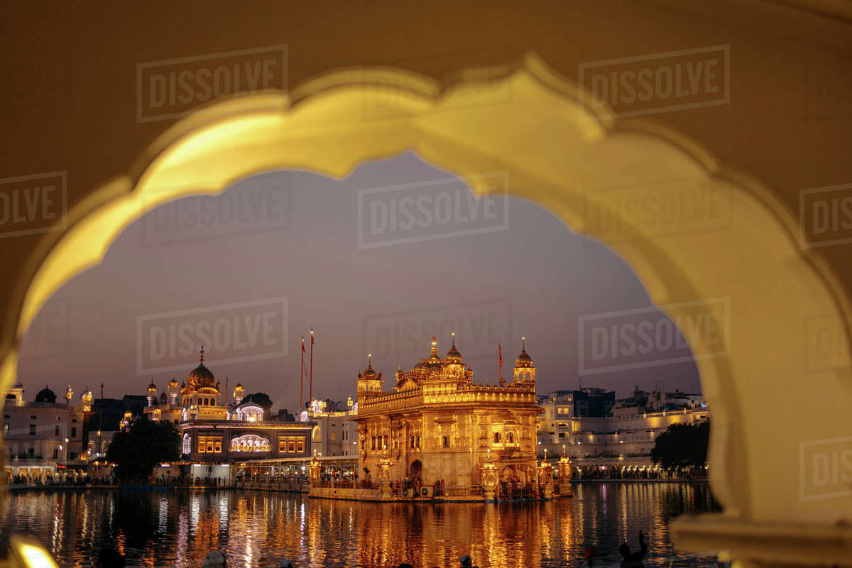 Golden Temple, a Sikh Gurdwara with pool of water and framed by a ...