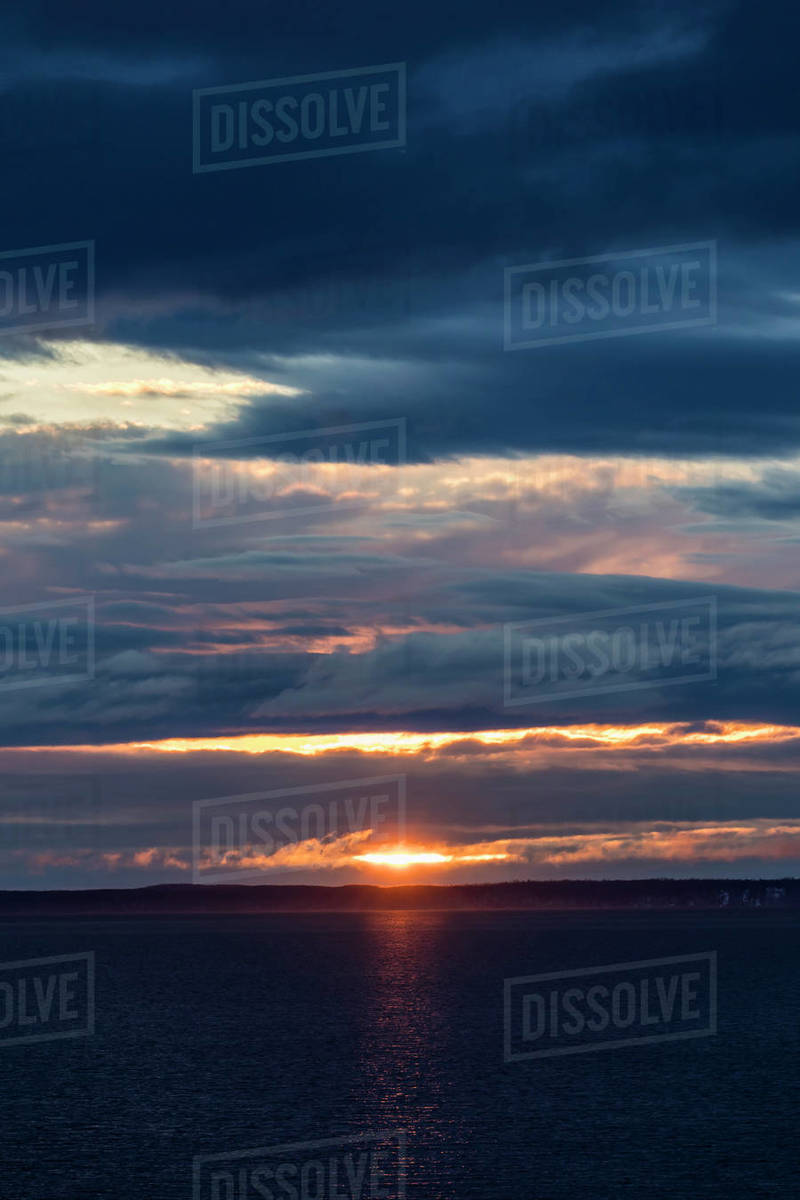 Dramatic clouds at the last light of sunset over the ocean at Turnagain ...