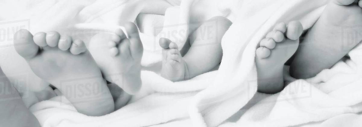 Different Sized Children's Feet - Stock Photo - Dissolve