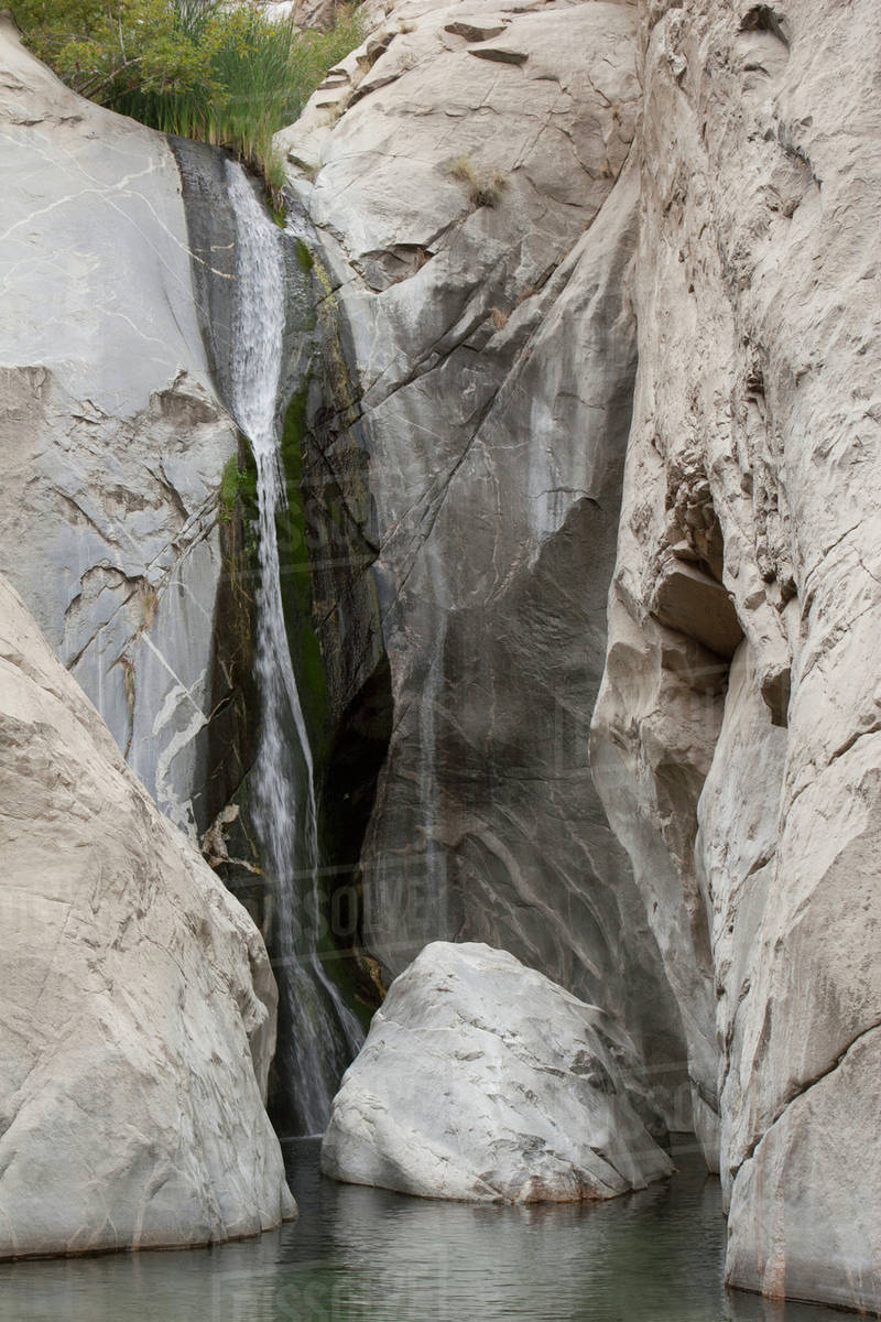 Waterfalls Along Rounded Cliff Rock In The Desert; Palm Springs ...