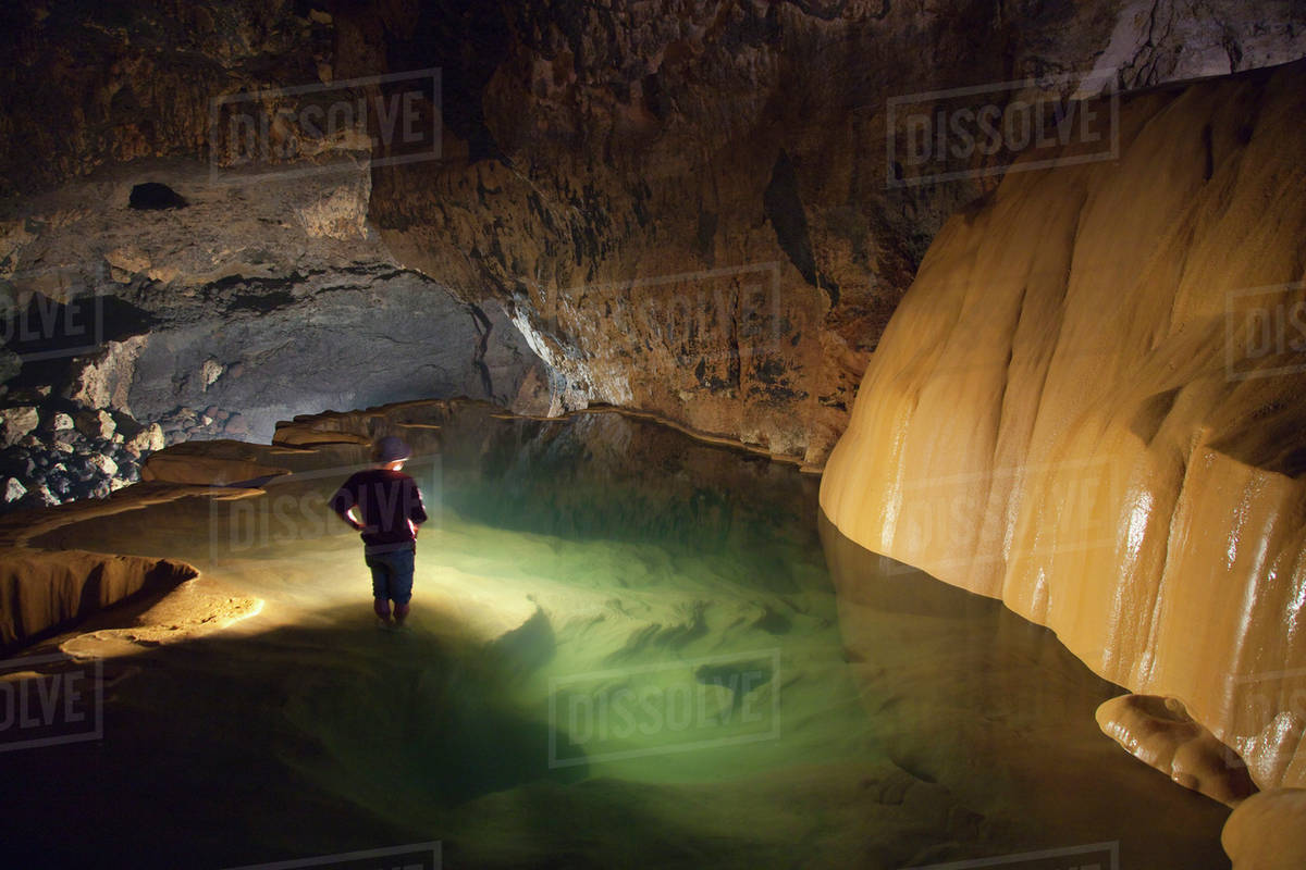 A Filipino Tour Guide Holds A Lantern Inside Sumaging Cave Or Big Cave ...