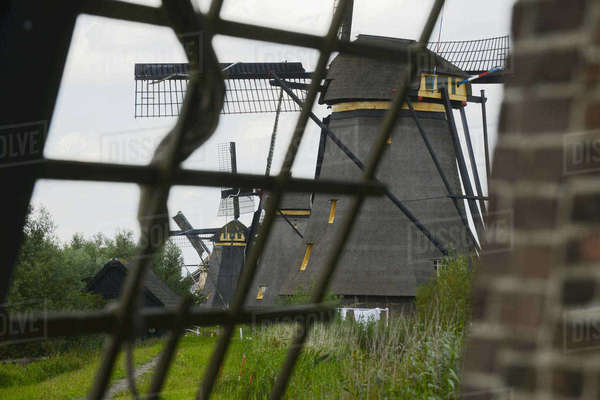 View of a row of traditional windmills through the framework of a ...