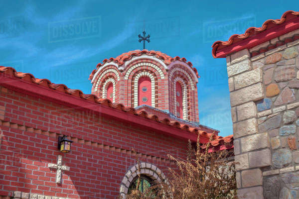 Close-up of ornate dome and clay tile rooftop with brick and stone ...