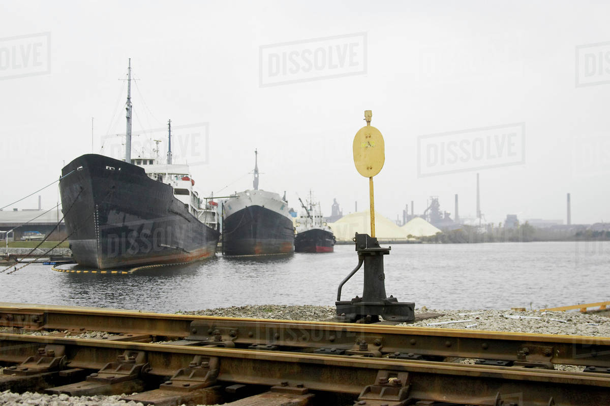 Train Track, Switch Stand, And Ships Against Industrial Back Drop ...