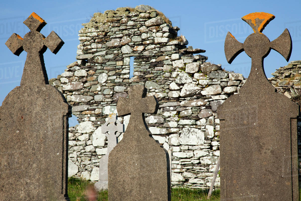 Tombstones In Front Of An Old Stone Wall Near Eyeries; County Cork ...