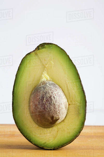 Close Up Of An Avocado Standing Upright Cut In Half With The Pit ...