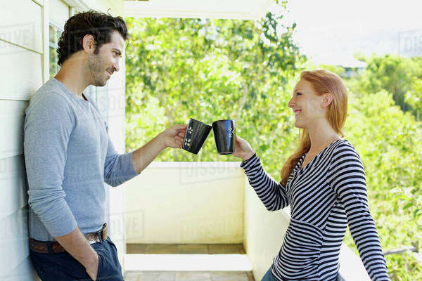 A Man And Woman Toast Each Other With Their Coffee Mugs;Wailua Kauai ...